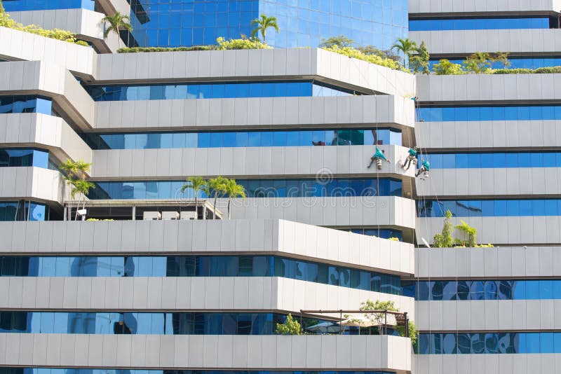 Man Cleaning Windows on a High Rise Building Stock Photo - Image of ...