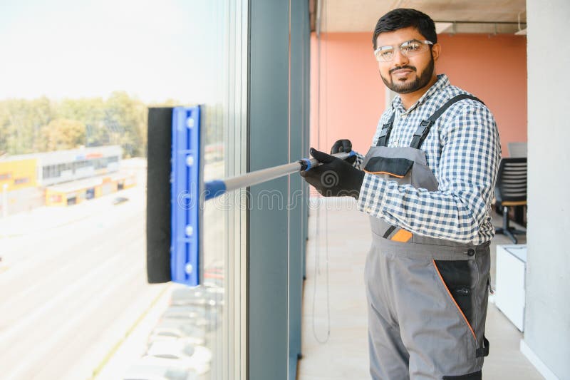 A Man Cleaning Windows. Men Washes the Windows Stock Photo - Image of ...