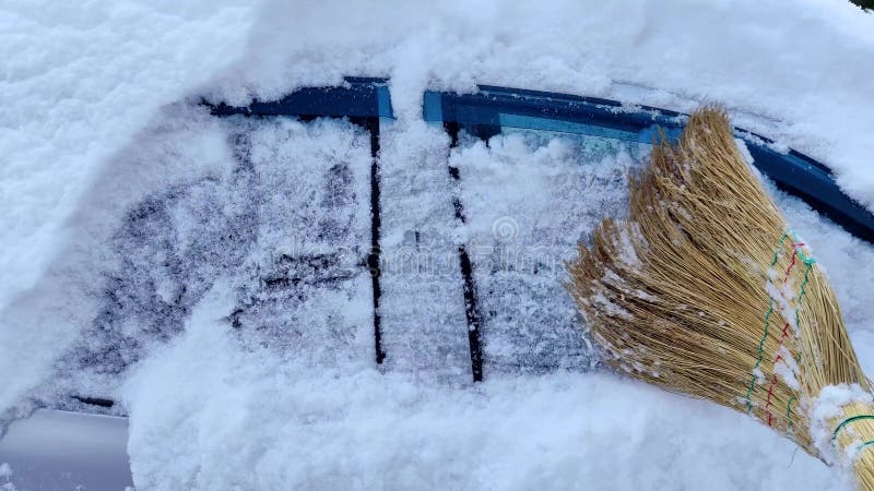 Man Cleans a Car of Snow with a Broom. First Person View Video Stock ...