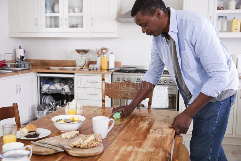 Man Clearing Breakfast Table and Loading Dishwasher Stock Photo - Image ...