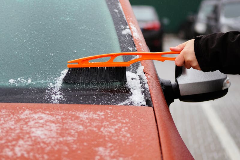 Man Clears Snow from Icy Windows of Car. Orange Brush in Mans Hand ...