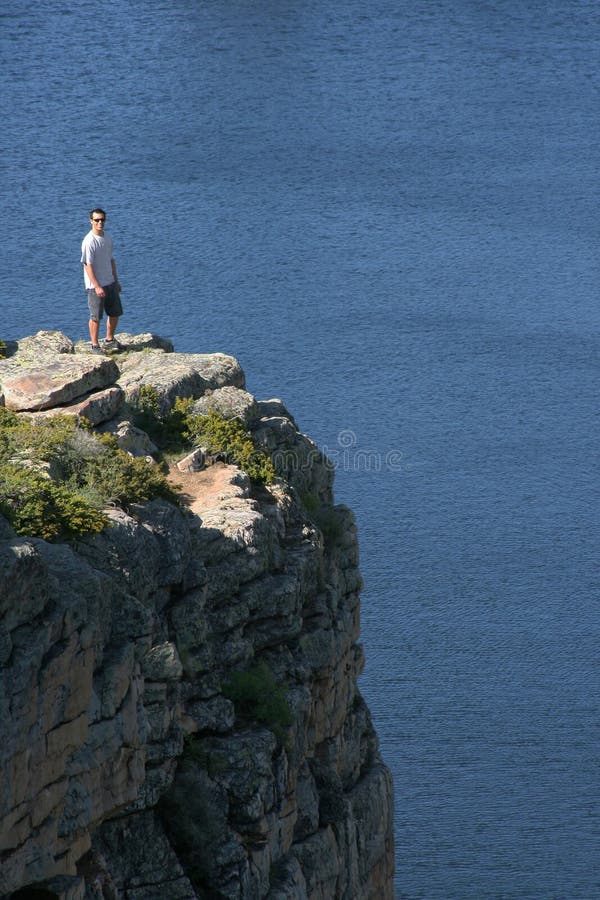 Man on cliff near lake stock image. Image of overlooking - 2745725