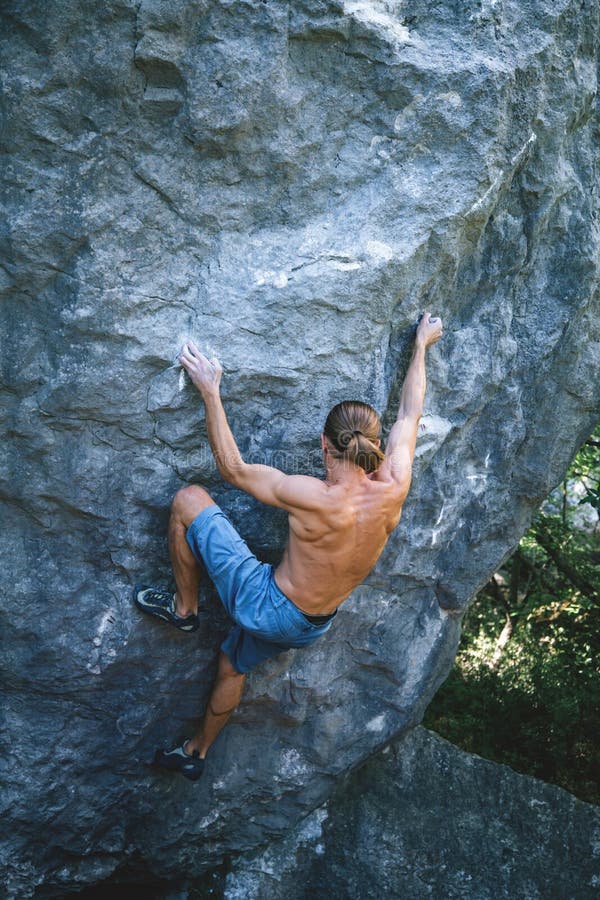 Man climbing bouldering. stock image. Image of forest - 150481661