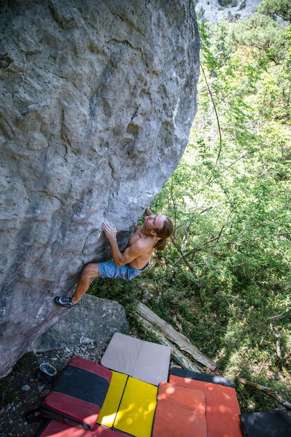 Man climbing bouldering. stock image. Image of forest - 150481661