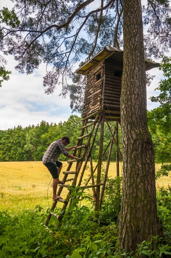 Man Climbing on hunter hut stock photo. Image of spring - 38715120