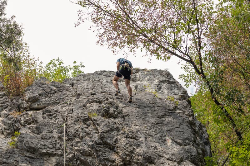 Man Climbing in the Mountains on a Step Rock Stock Image - Image of ...