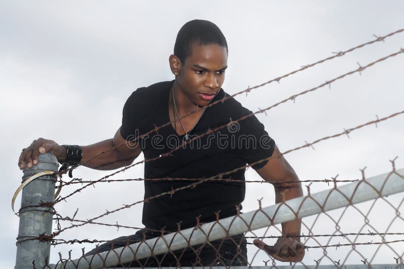 Man Climbing Over Barbed Wire Fence Stock Images - Image: 19070614