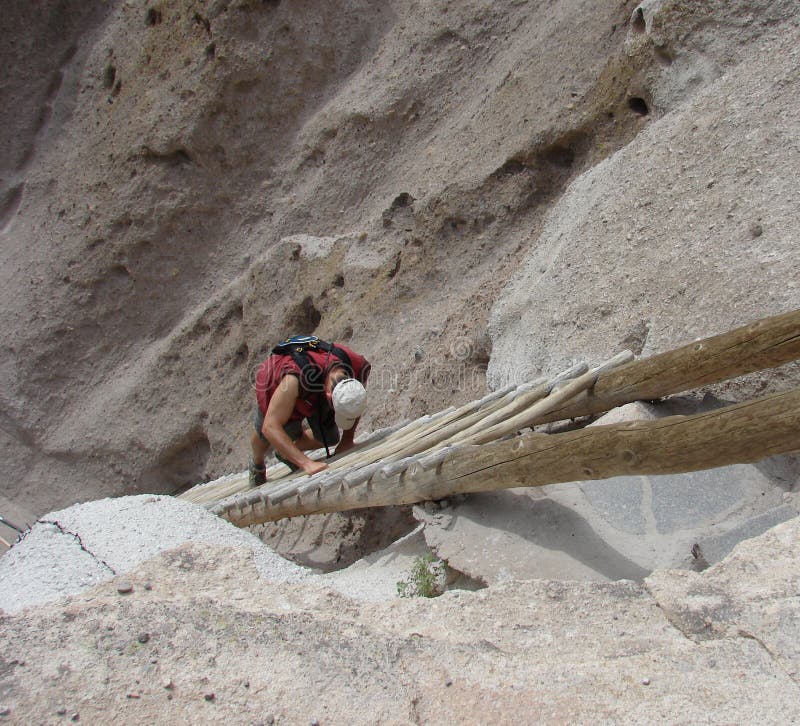 Man Climbing Steep Ladder at Cliff Dwellings Stock Photo - Image of ...