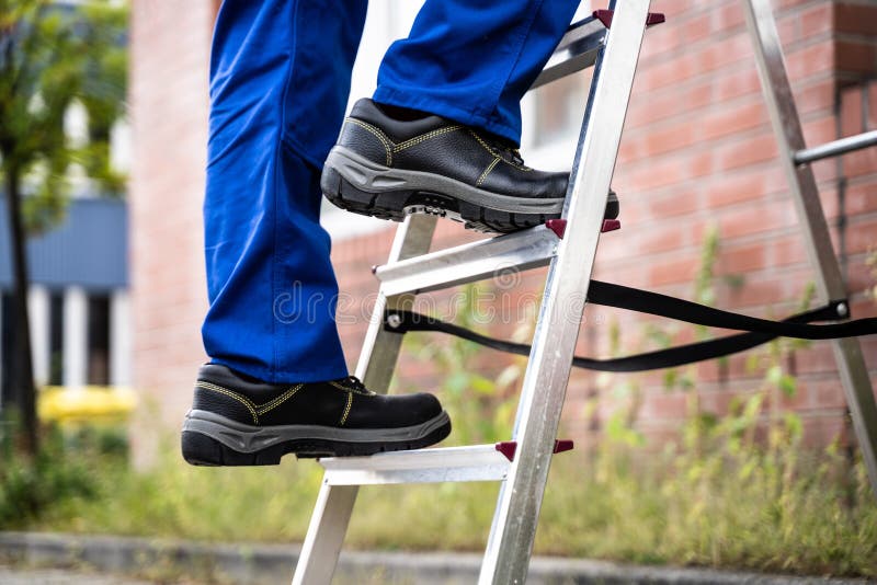 Man Climbing Step Ladder stock photo. Image of plumber - 232158566