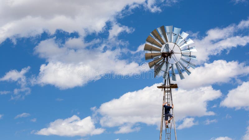 Man climbing a windmill stock photo. Image of american - 56595950