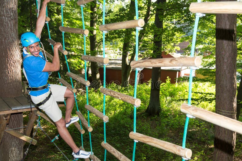 Man Climbs Over Obstacles at High Rope Court Stock Photo - Image of ...