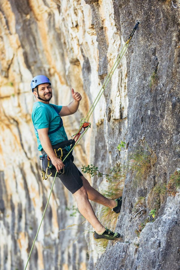 Man Climbs on the Rock Wall. Climbing Gear. Climbing Equipment Stock ...