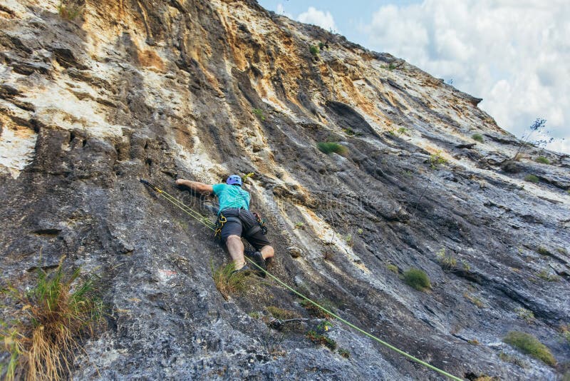 Man Climbs on the Rock Wall. Climbing Gear. Climbing Equipment Stock ...