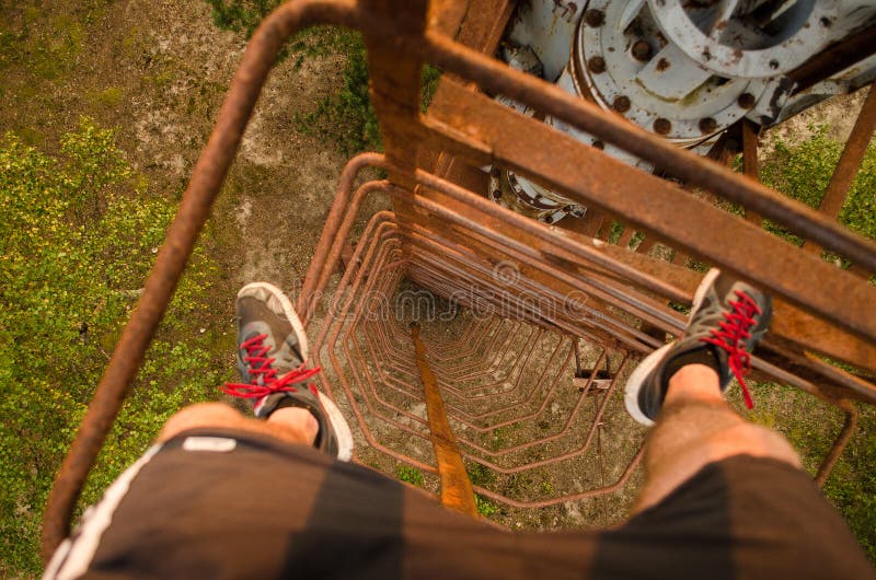 A Man Climbs a Rusty Metal Tower Stock Photo - Image of wooden ...