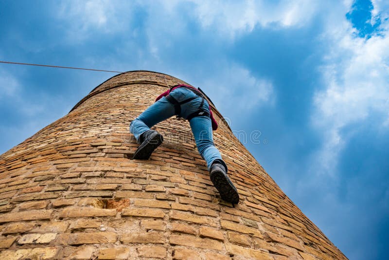 A Man Climbs Up a Tower with a Rope Stock Image - Image of hanging ...