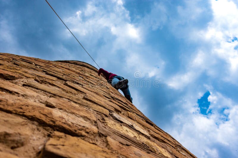 A Man Climbs Up a Tower with a Rope Stock Photo - Image of climbing ...