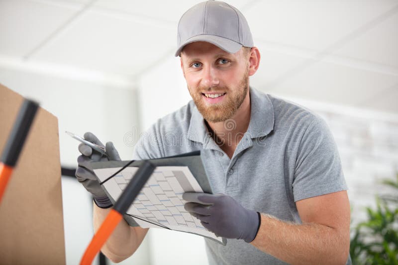 Man with Clipboard and Cardboard Boxes on Trolley Stock Image - Image ...