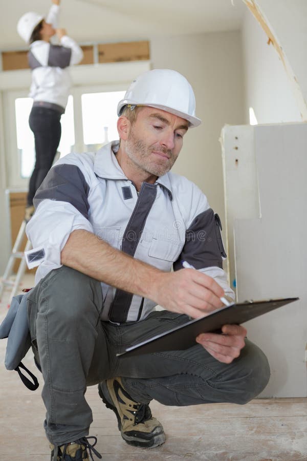 Man with Clipboard on Worksite Stock Image - Image of site, uniform ...