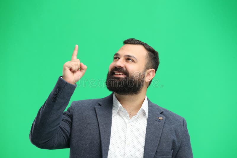 Man, Close-up, on a Green Background, Pointing Up Stock Photo - Image ...