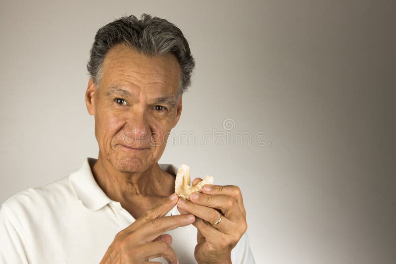 Man Closely Examining the Mold of His Lower Teeth Stock Photo - Image ...