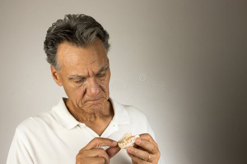 Man Closely Examining the Mold of His Lower Teeth Stock Photo - Image ...