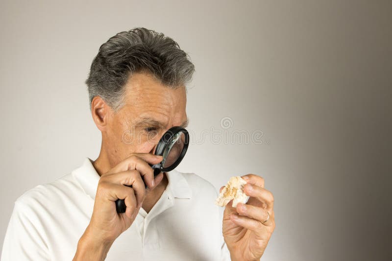 Man Closely Examining the Mold of His Lower Teeth Stock Photo - Image ...