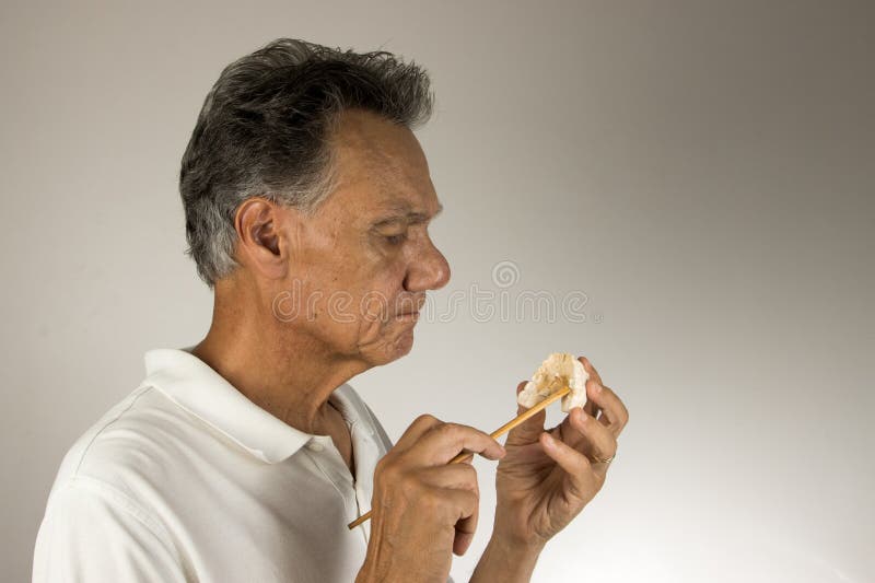 Man Closely Examining the Mold of His Lower Teeth Stock Photo - Image ...