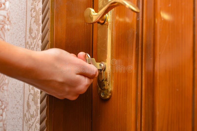 The Man Closes the Door Lock in the Apartment Stock Image - Image of ...