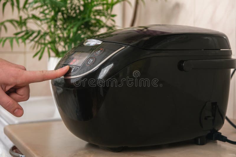 Man Closes Lid of Slow Cooker and Selects Cooking Program, Temperature ...