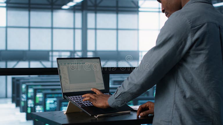 Man Coding on Data Center, Testing Failover Scenarios Using Notebook ...