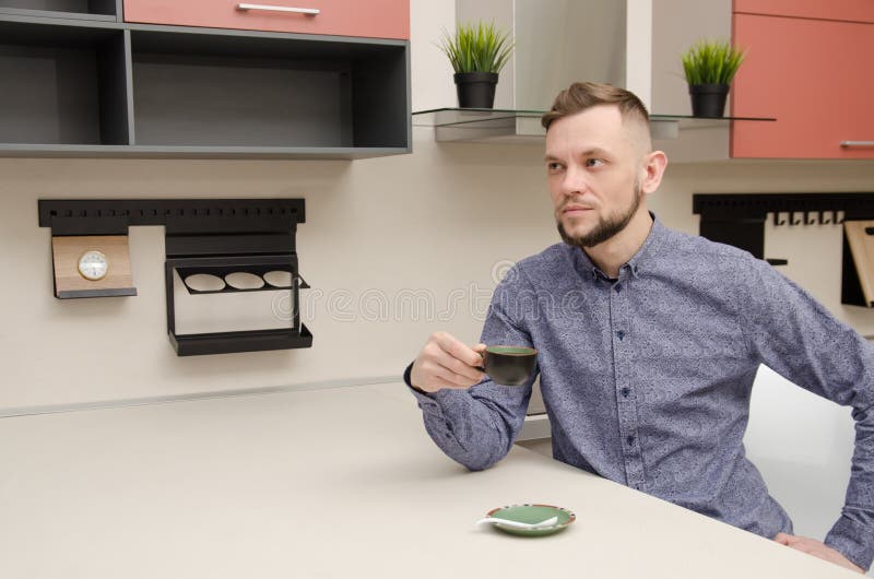 Man with Coffee Cup at the Table in Modern Kitchen Stock Image - Image ...