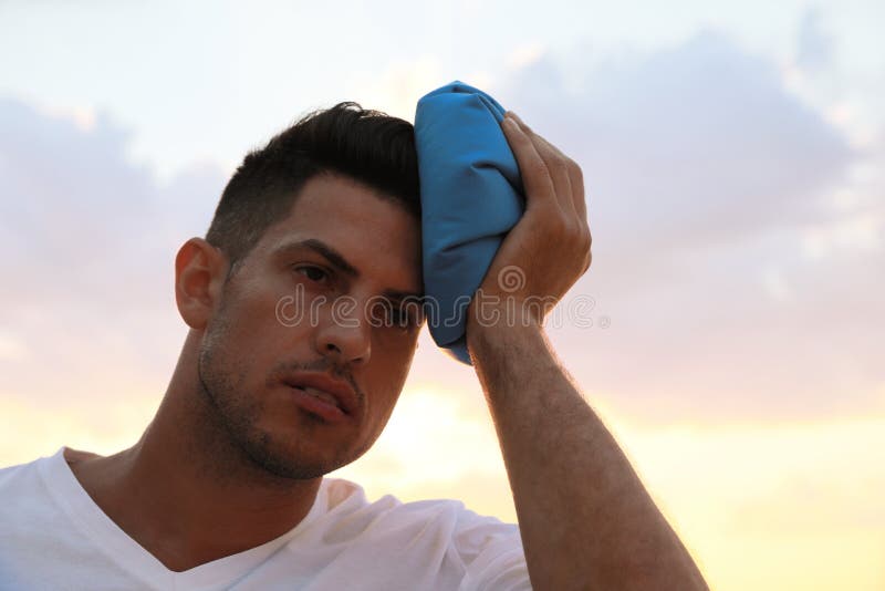 Man with Cold Pack Suffering from Heat Stroke Outdoors Stock Image ...