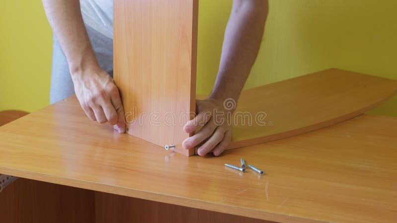 Man Is Collecting Parts Of Computer Table Screwing Shelf Using Bolts Stock Footage Video Of