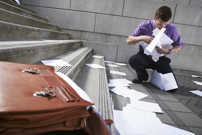 Man Collecting Spilled Paperwork from Steps Stock Photo - Image of ...