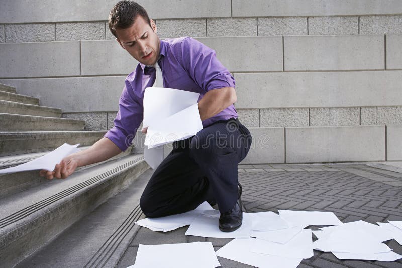 Man Collecting Spilled Paperwork from Steps Stock Image - Image of ...