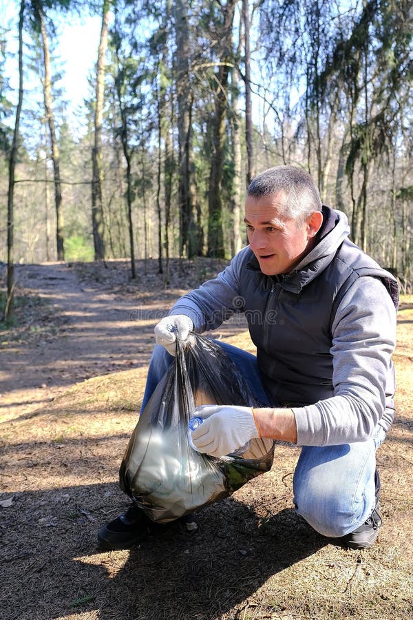 A Man Collects Garbage. Puts it in a Garbage Bag. the Problem of ...