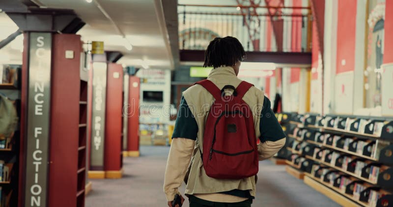 Man, College and Student Walking in Library for Study Material ...