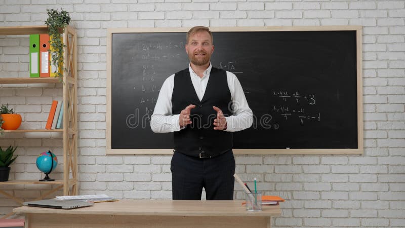 Man College Teacher in Classroom in Front of Chalkboard Explaining ...