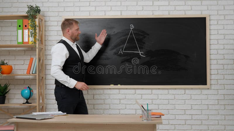 Man College Teacher in Classroom in Front of Chalkboard Explaining ...