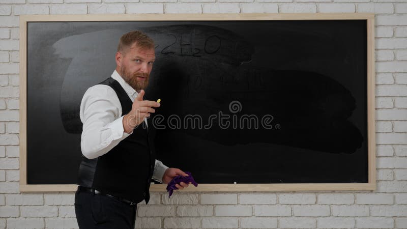 Man College Teacher in Classroom in Front of Chalkboard Explaining ...