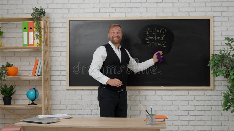 Man College Teacher in Classroom in Front of Chalkboard Explaining ...