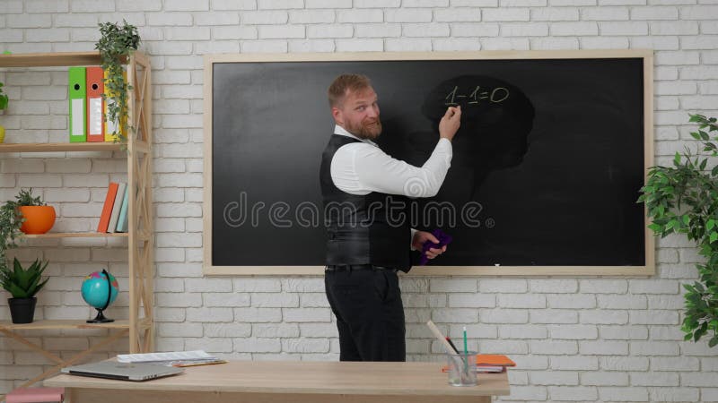 Man College Teacher in Classroom in Front of Chalkboard Explaining ...