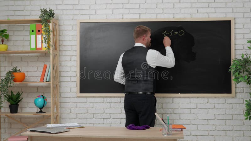 Man College Teacher in Classroom in Front of Chalkboard Explaining ...