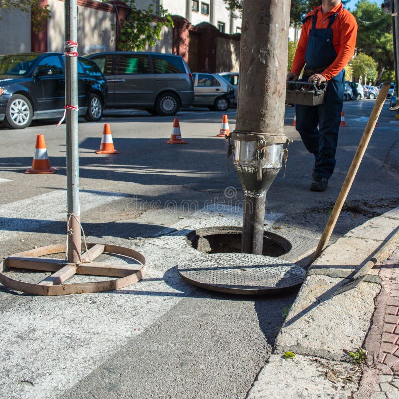 A Man is Commanding a Machine for Cleaning the Manholes in the S Stock ...
