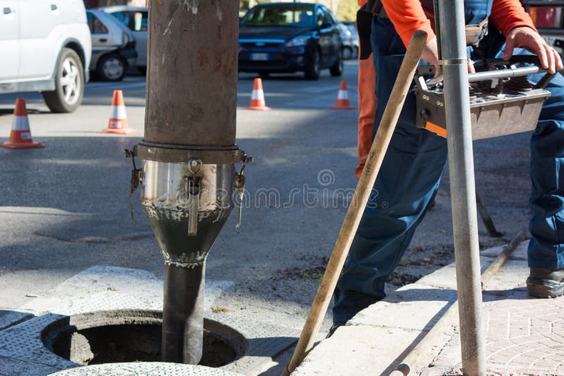 A Man is Commanding a Machine for Cleaning the Manholes in the S Stock ...