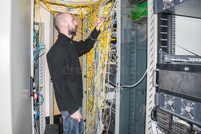 An Engineer Connects Magistral Optical Fiber Wires. a Man Commutes ...