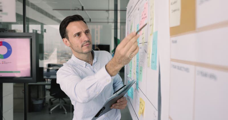 Man Comparing Information on Sticky Notes with Data in Folder Stock ...