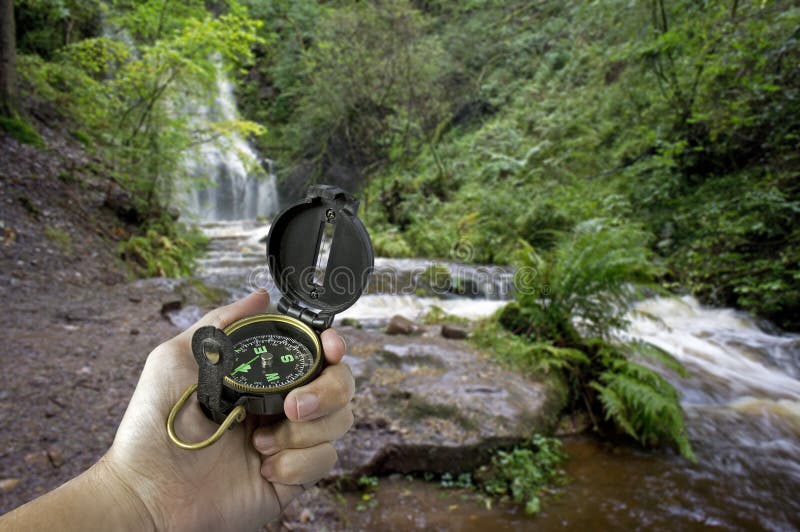 Man with Compass Near Waterfall Stock Image - Image of foliage, army ...