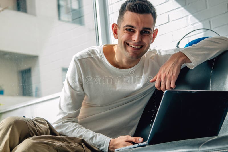Man with computer at home stock image. Image of casual - 218560387
