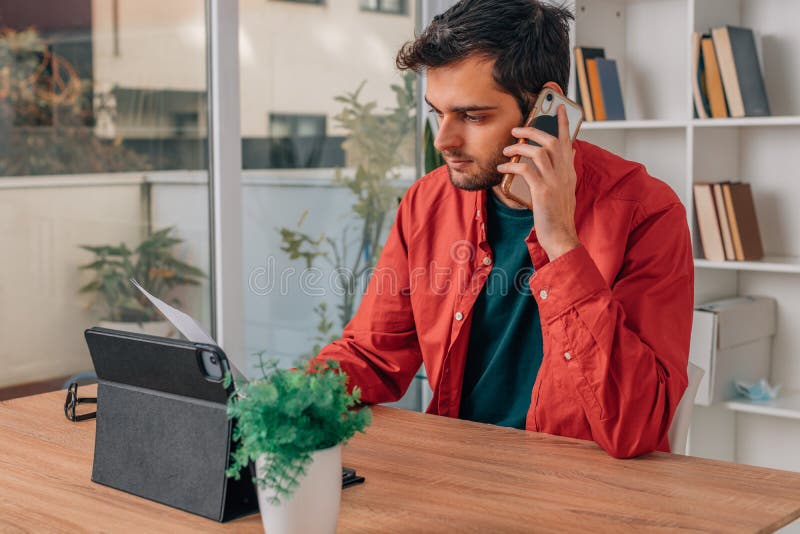 Man with Computer and Mobile Phone at Home at Desk Stock Photo - Image ...